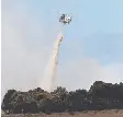 70 fireys, helitanker battle blaze - PressReader