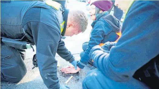 Activist glues himself to podium on live TV - PressReader