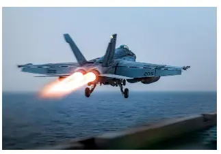 US fighter jet rolls off aircraft carrier as ship reportedly swerves Houthi fire - PressReader