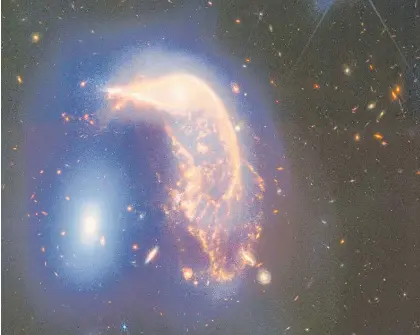 Two merging galaxies in an embrace - PressReader