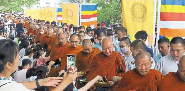 67 monks in alms ceremony for 67th National Day - PressReader