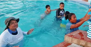 Swimming instructor teaches the young - PressReader