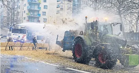 EU farmers spray cops with manure - PressReader