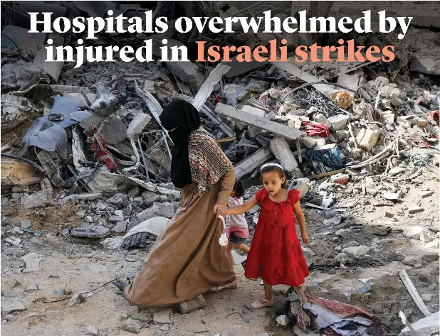 Hospitals overwhelme­d by injured in Israeli strikes - PressReader