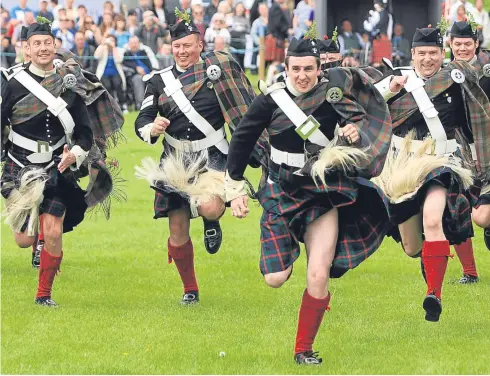 Run! The Atholl Highlander­s race at Blair Castle, where crowds flocked ...
