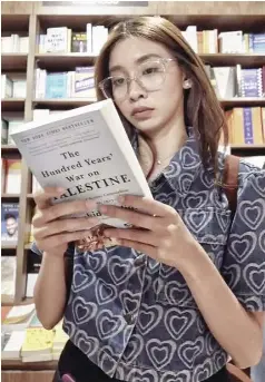Browsing books with beauty titlist, vlogger Mipsen Calves - PressReader