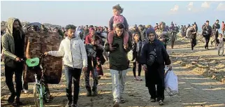 Throngs of displaced residents head north after hostage breakthrou­gh ...